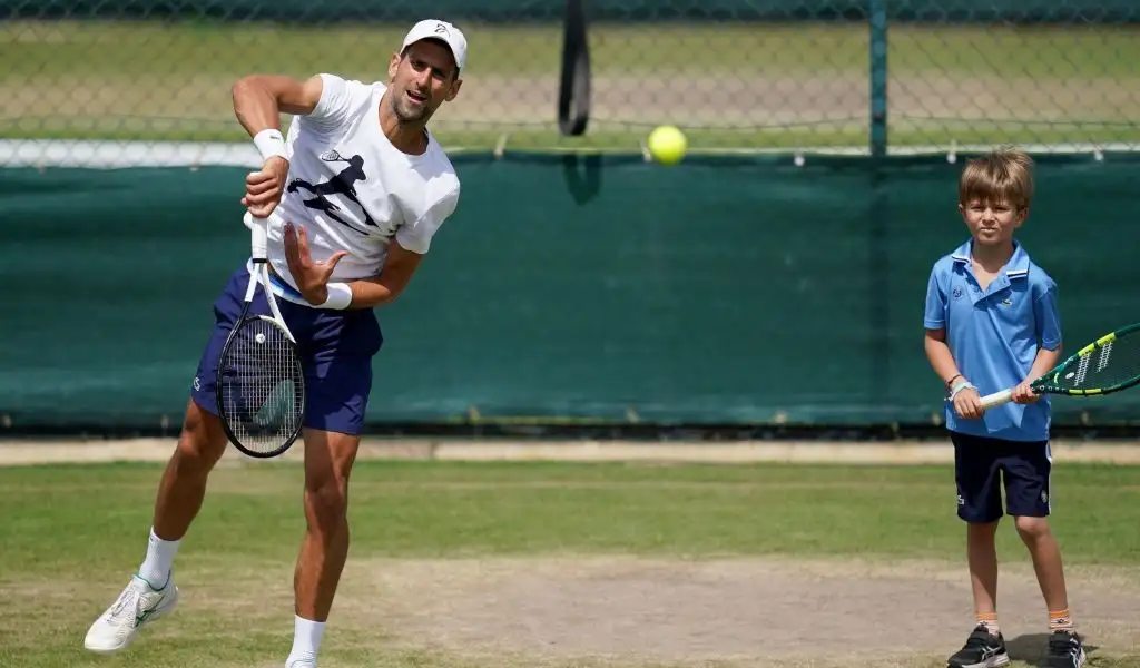 Novak Djokovic's son Stefan takes the applause as he hits practice courts